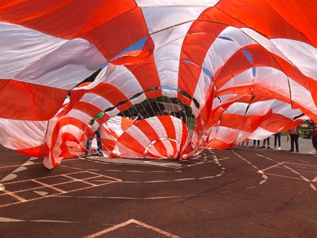 Apollo Block II Command Module parachute, 83½ feet in diameter. Red ...