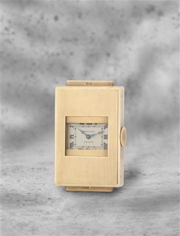 A fine and rare 9K gold manual wind guillotine shutter purse watch ...