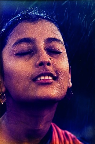 Indian girl in early monsoon rains by Brian Brake on artnet