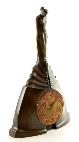 A parabola shaped bronze mantle clock with a standing female figure on ...