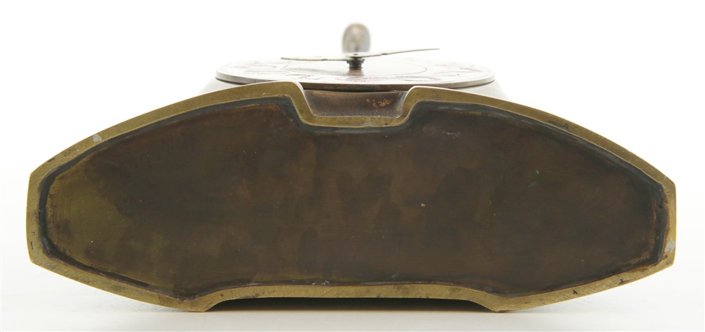 A parabola shaped bronze mantle clock with a standing female figure on ...