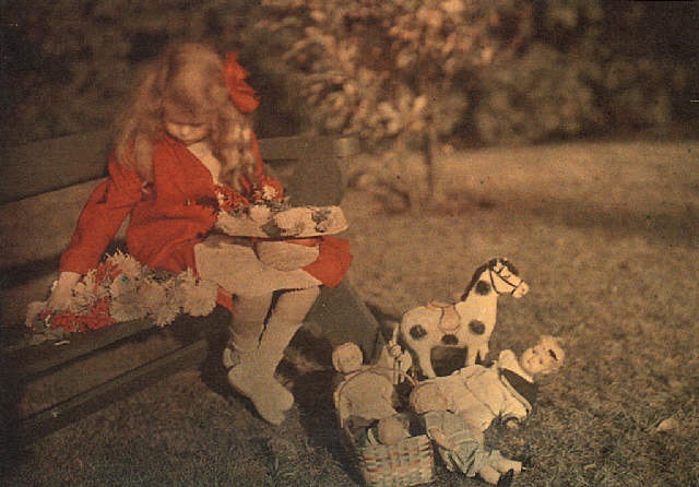 Georgia Engelhard in a red coat, with flowers and toys by Alfred ...