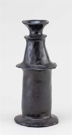 A stoneware vase with pinched flanges covered in thick cobalt and iron ...