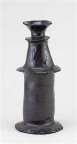 A stoneware vase with pinched flanges covered in thick cobalt and iron ...