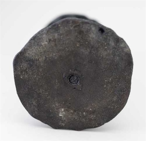 A stoneware vase with pinched flanges covered in thick cobalt and iron ...
