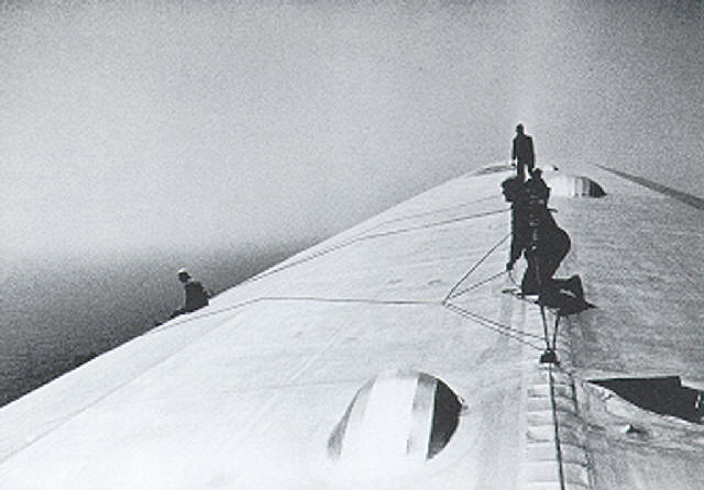 Graf Zeppelin crewmen repair damage in flight by Alfred Eisenstaedt on artnet