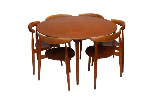 a teak Heart dining table and chairs, with six chairs raised on tripod ...