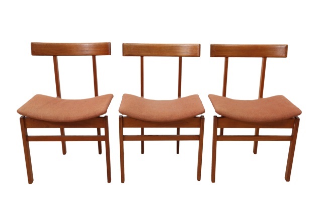 a teak dining table, with a circular table top raised over offset legs ...