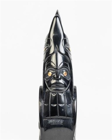 a carved argillite totem pole, depicting a Raven and Bear holding Woman ...