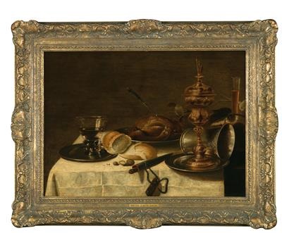 A partially draped table with precious vessels, bread rolls, lemons and ...