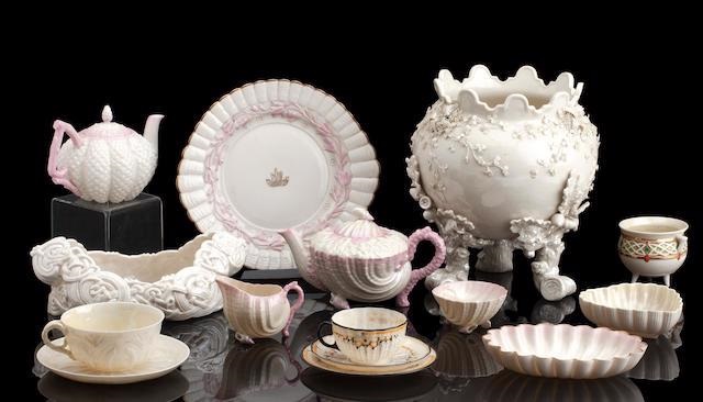 A BELLEEK JARDINIERE, The ovoid body on three branch feet and applied ...