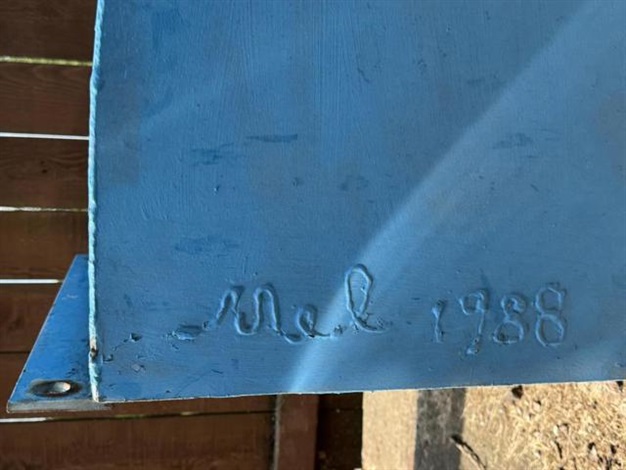 Red figure wearing a ball cap with hands behind his head, seated a top ...