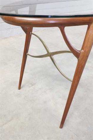 a brass-mounted walnut dining table by Ico Parisi on artnet