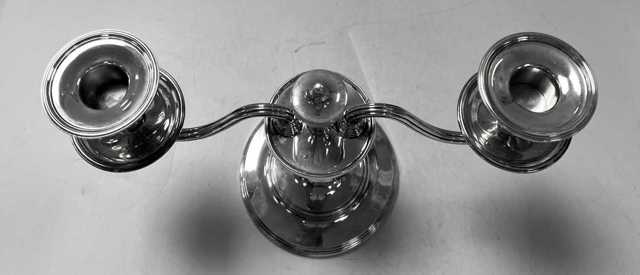 A visual pair of Elizabeth II silver two light metamorphic candelabra ...