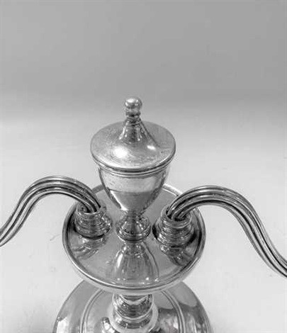 A visual pair of Elizabeth II silver two light metamorphic candelabra ...