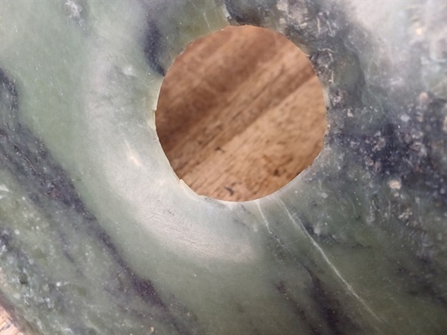 A CHINESE ARCHAIC MOTTLED GREEN JADE DISC, BI. Neolithic Period on artnet