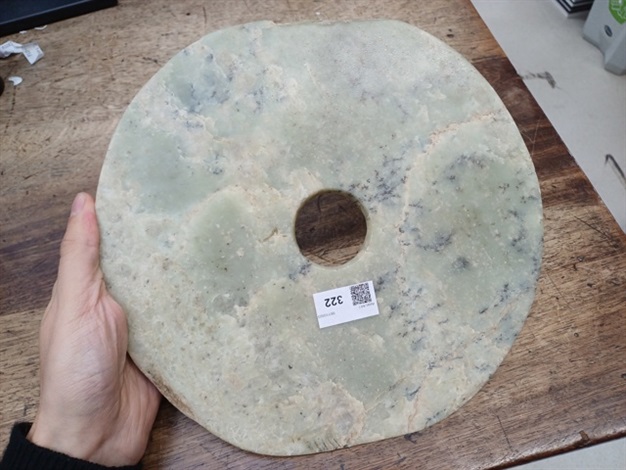 A LARGE CHINESE ARCHAIC GREEN JADE DISC, BI. Neolithic Period, possibly ...