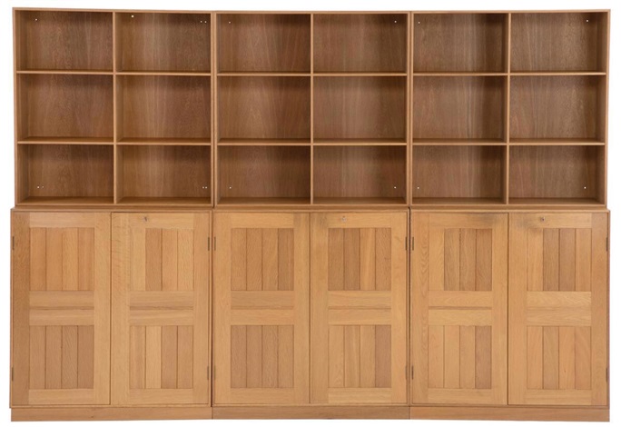 A solid oak wall unit comprising three cabinets, three bookcases and three plinths by Mogens ...