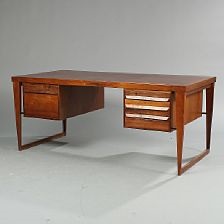 Freestanding rosewood desk mounted on runner legs, front with six ...
