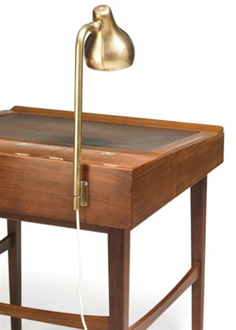 FJ 42. Freestanding nutwood writing desk with tapering legs and brass ...