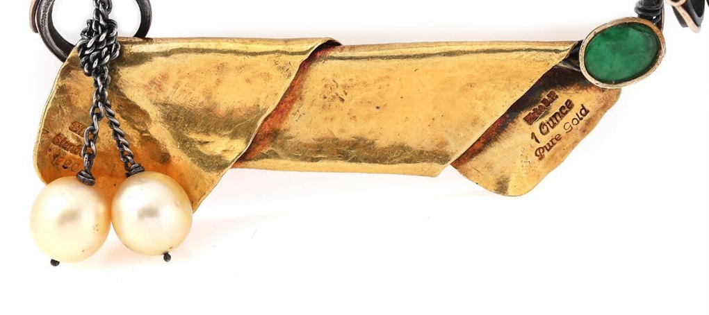 An emerald and pearl brooch set with an emerald and two pearls by Birte ...