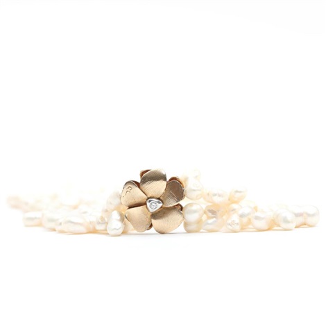 A flower clasp set with brilliant-cut diamond and faceted sapphire ...